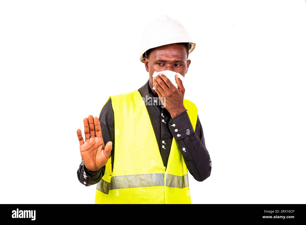 young sick engineer man wearing safety vest and helmet holding ...