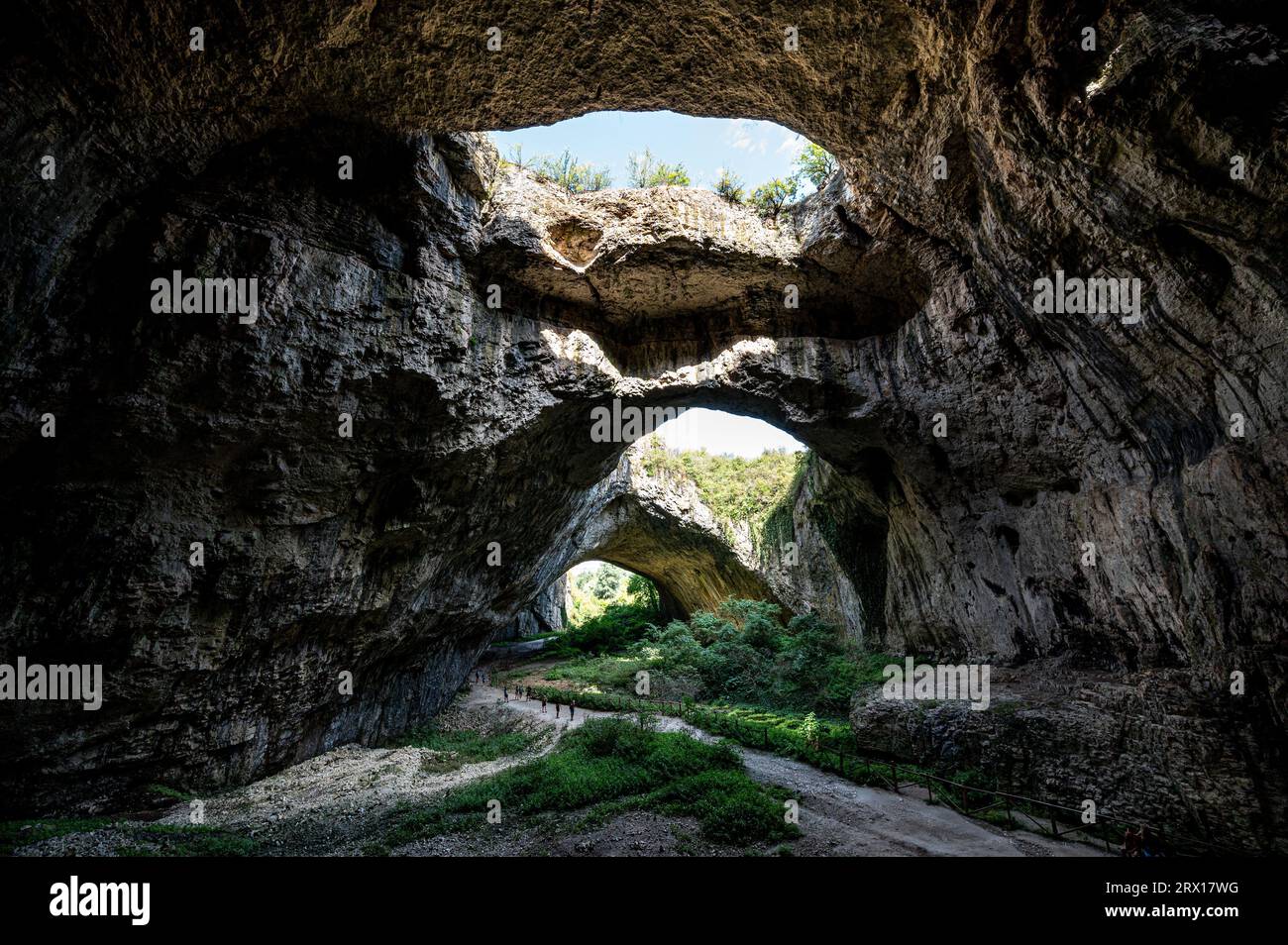 A stunning view of Devetashka Cave in Bulgaria, featuring rocky walls ...