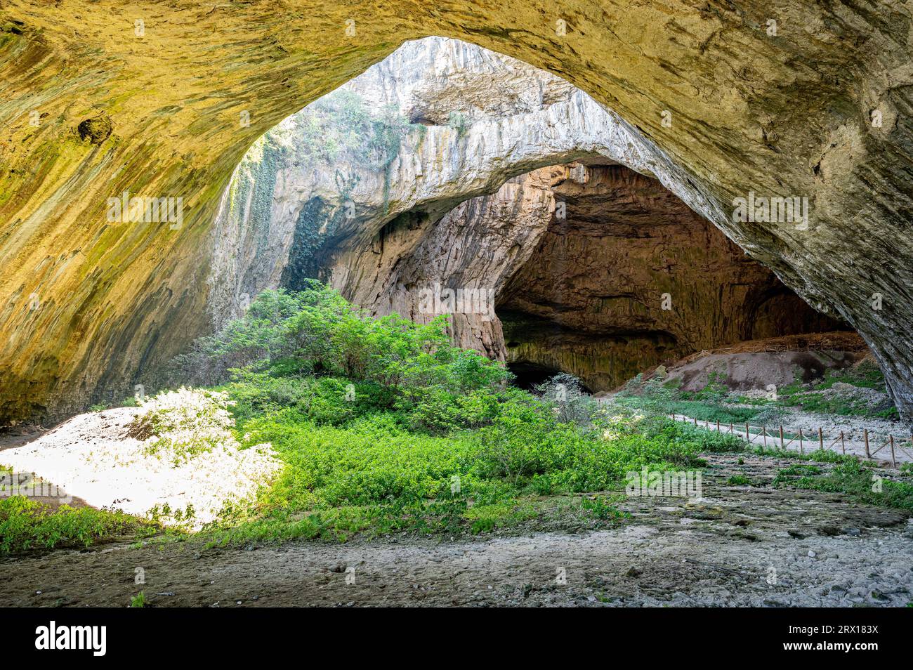 A stunning view of Devetashka Cave in Bulgaria, featuring rocky walls ...