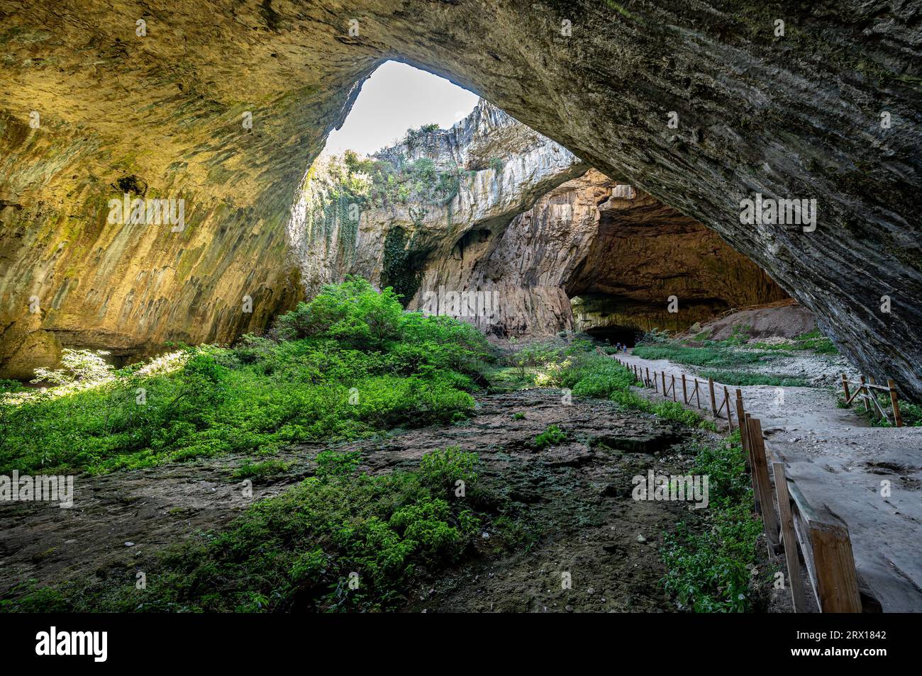 A stunning view of Devetashka Cave in Bulgaria, featuring rocky walls ...