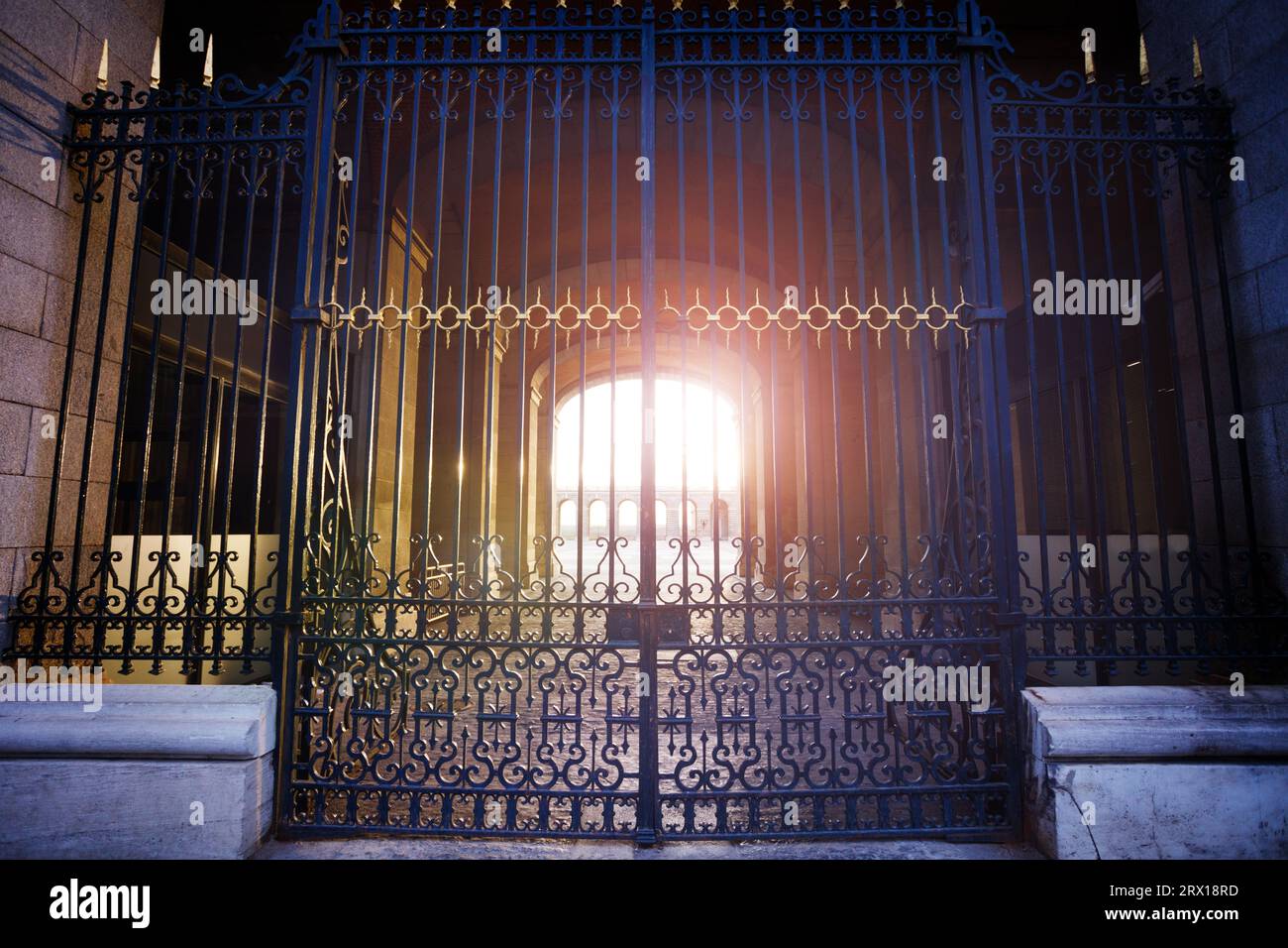 Entrance gates to Royal Palace of Madrid lit at sunset Stock Photo - Alamy