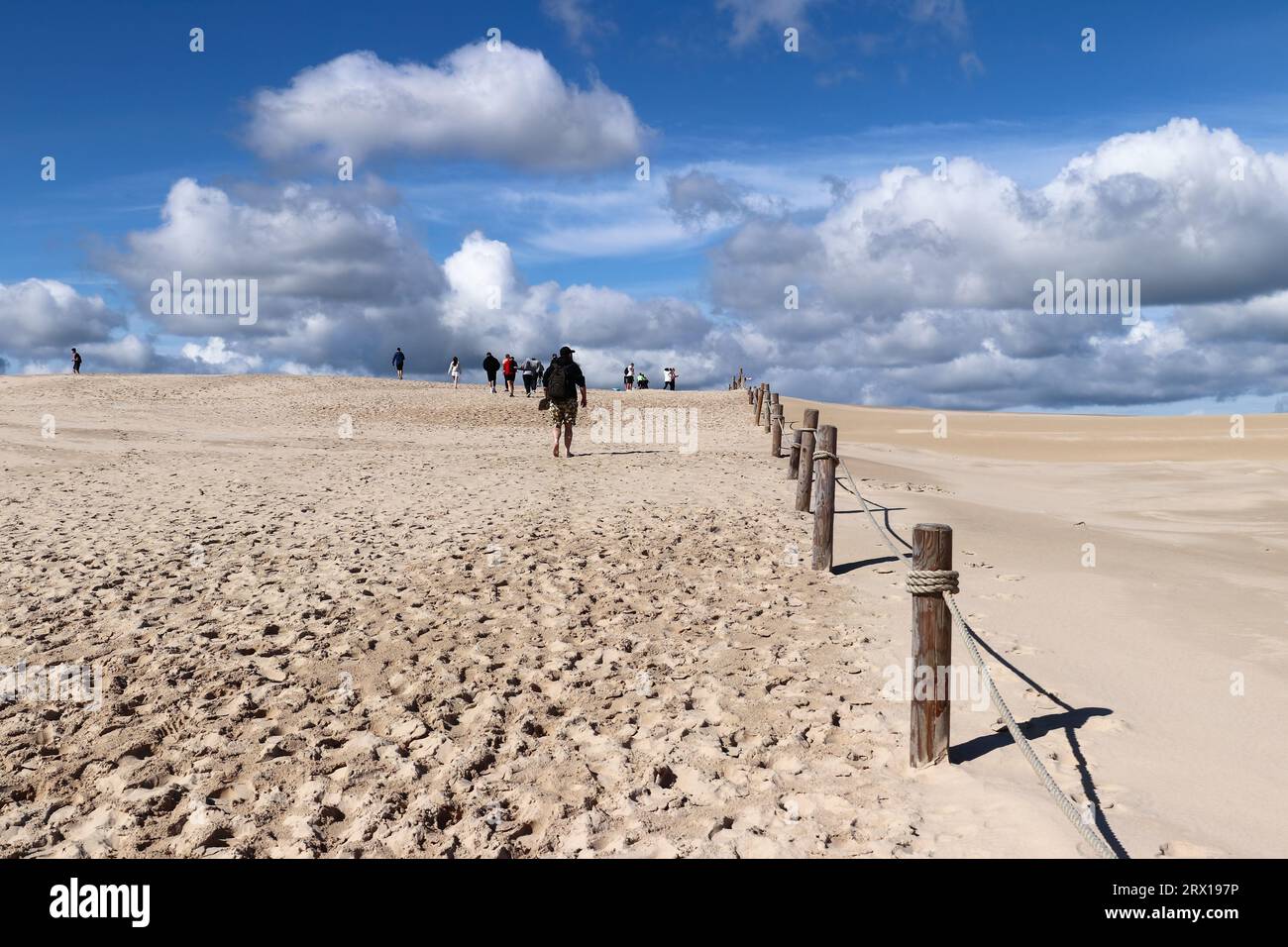 Beachgoers on the white sand dunes of Leba in the Slovincian National ...