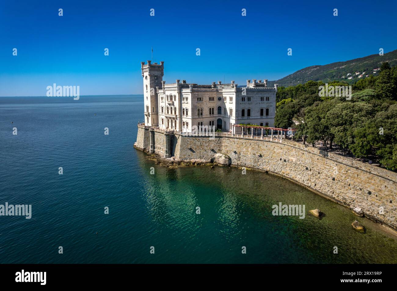 An aerial of the Miramare Castle in the scenic Gulf of Trieste in Italy ...