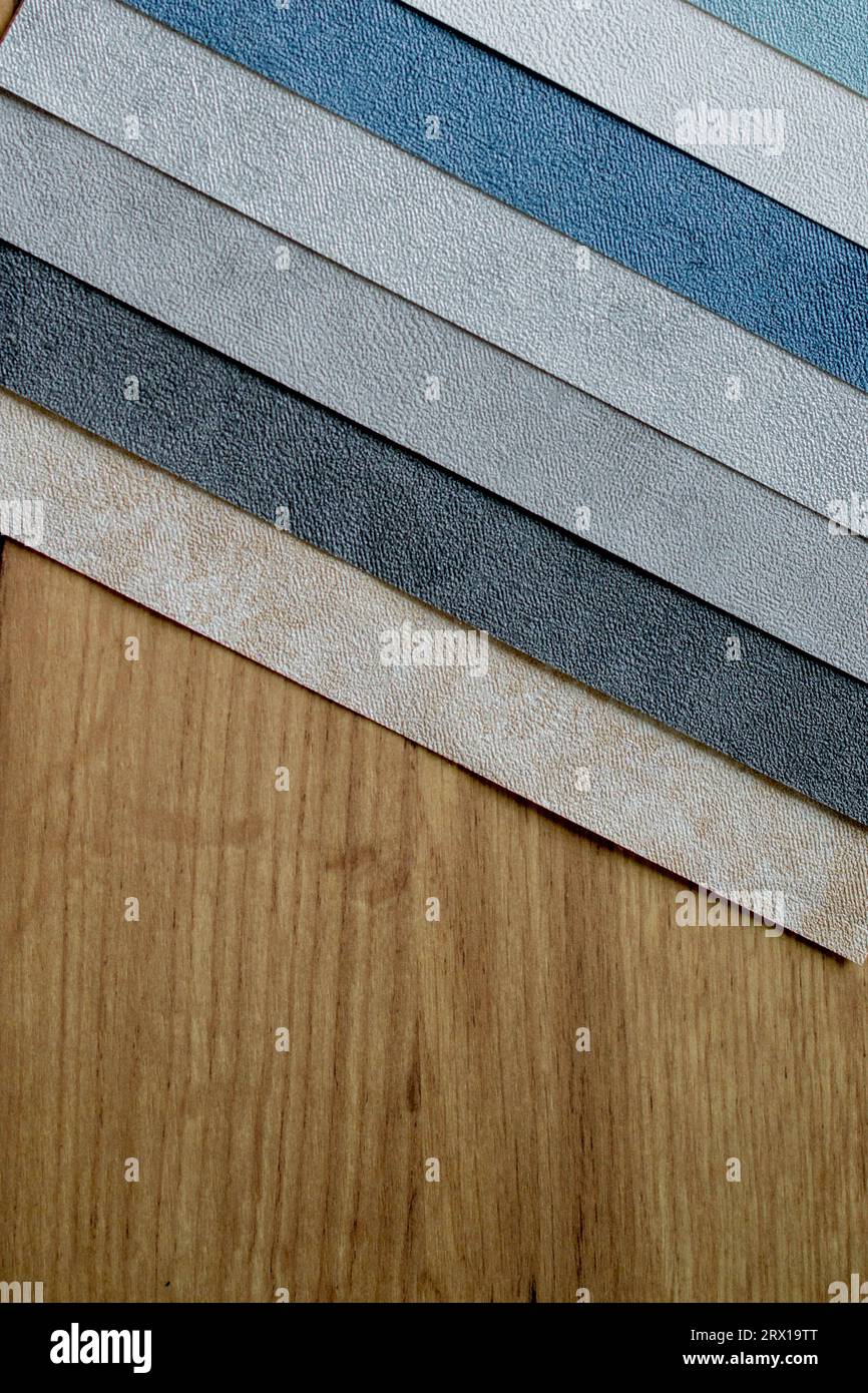 A collection of interior wallpaper samples in textured blue shades ...