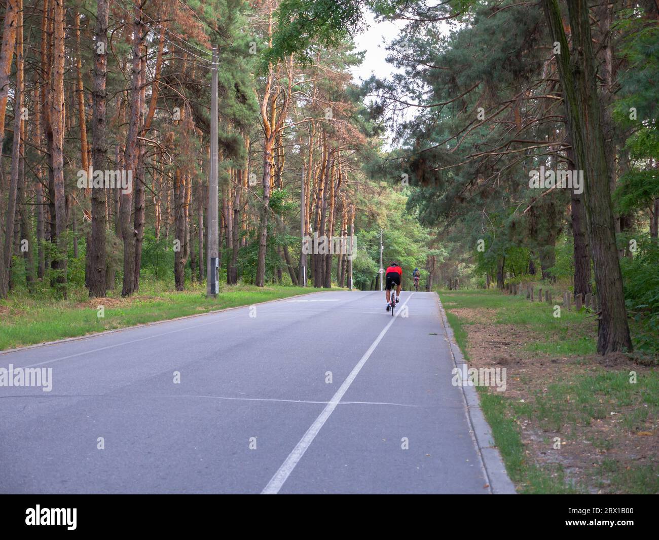 Bicyclist riding down two lane hi-res stock photography and images - Alamy
