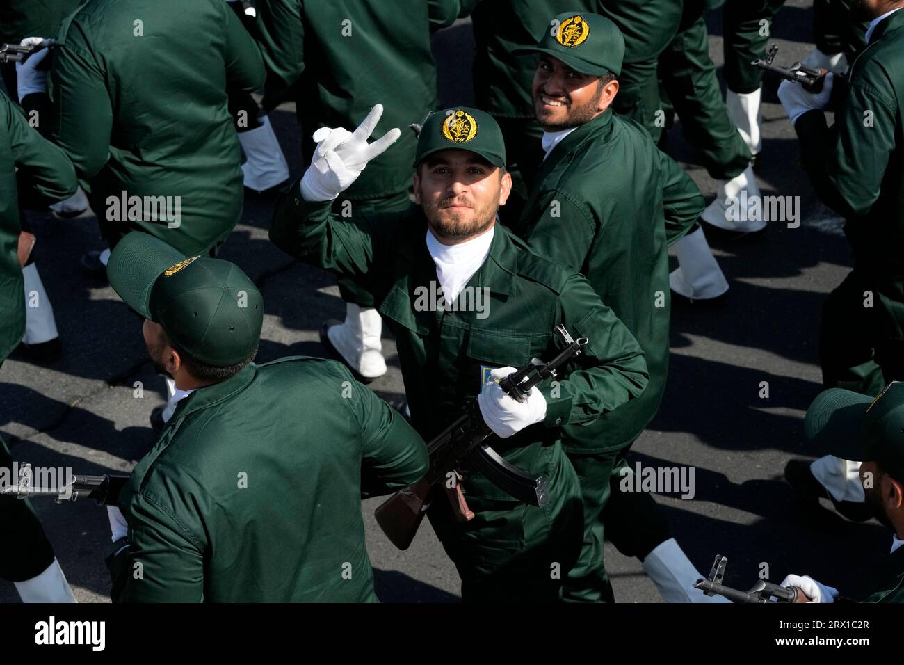 A member of Iran's Revolutionary Guard flashes a victory sign at the ...