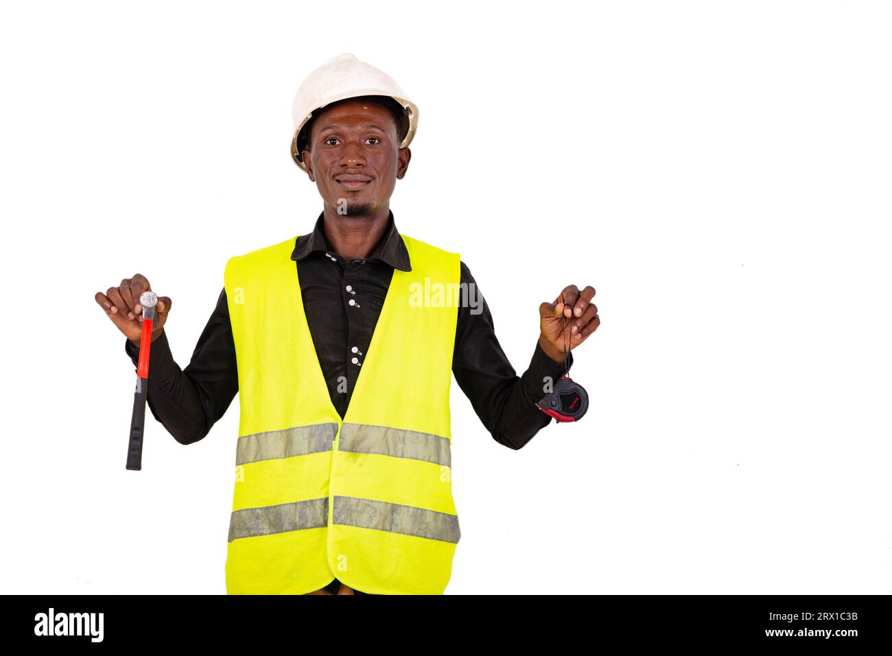 young man engineer wearing green vest and hard hat while holding hammer ...