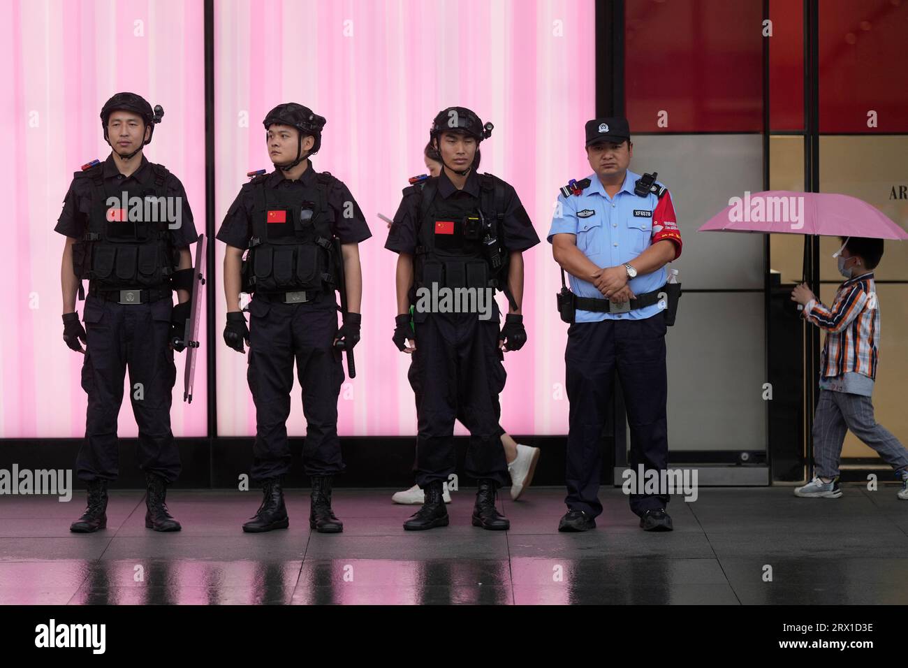 Chinese police officers stand outside of West Lake ahead of the 19th ...