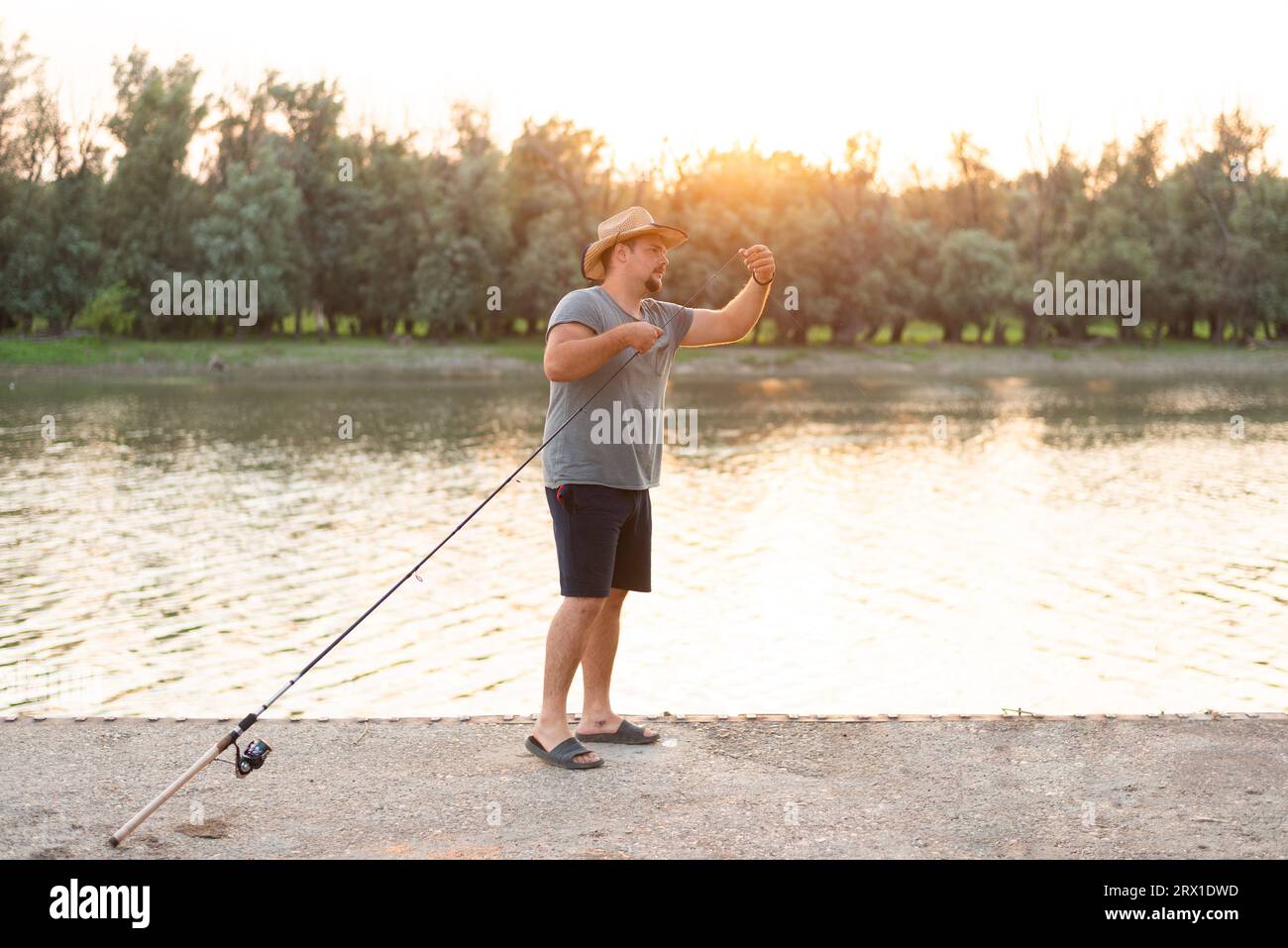 Old man with fishing rod hi-res stock photography and images - Alamy