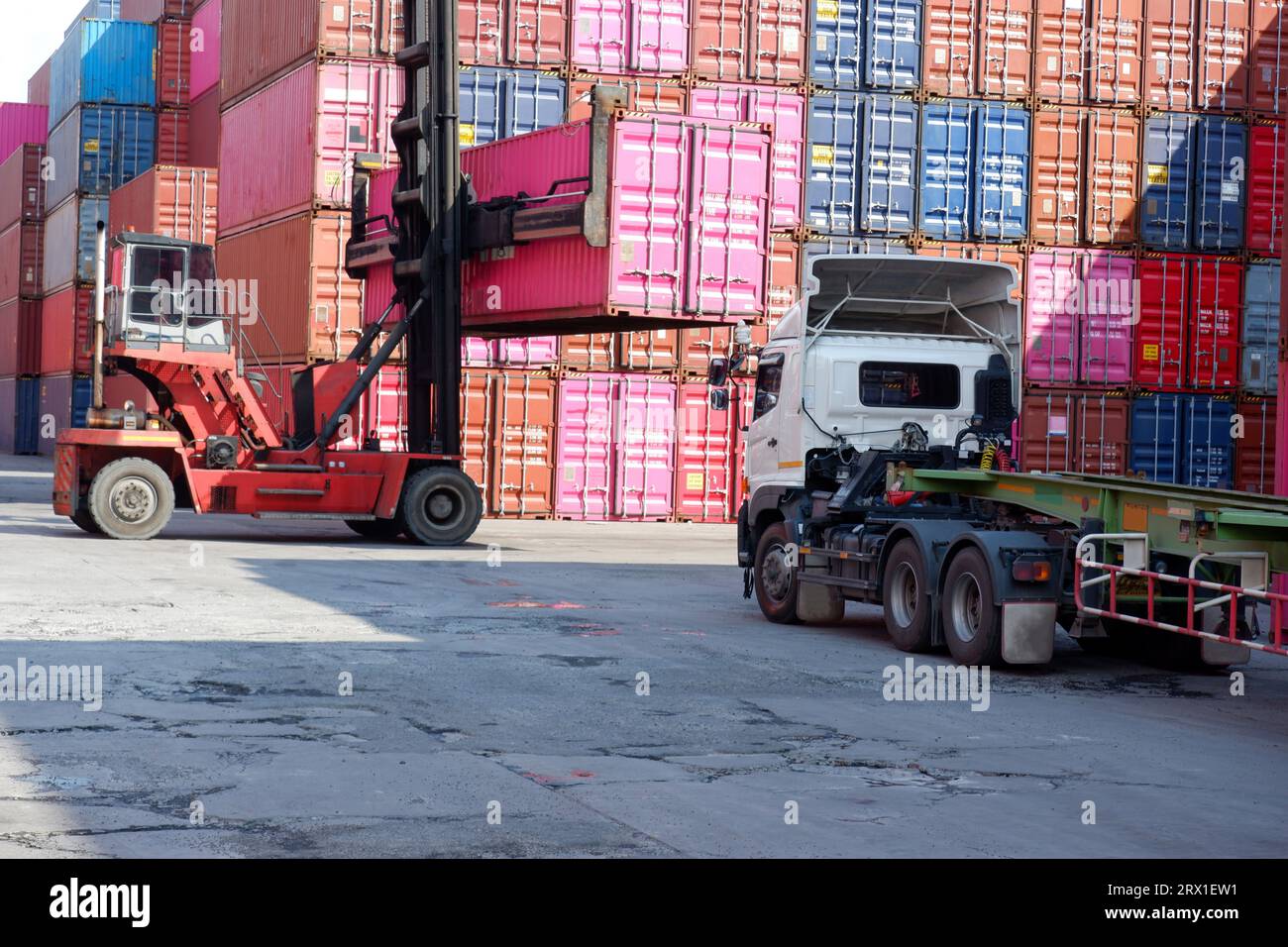 A container forklift sits behind a stack of containers Stock Photo - Alamy