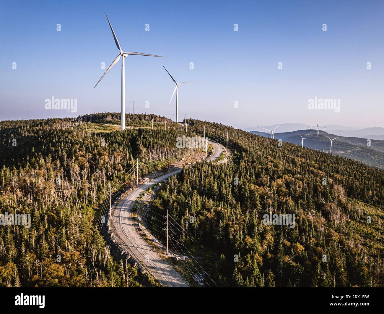 Access road snakes up mountain towards clean energy wind farm Stock ...