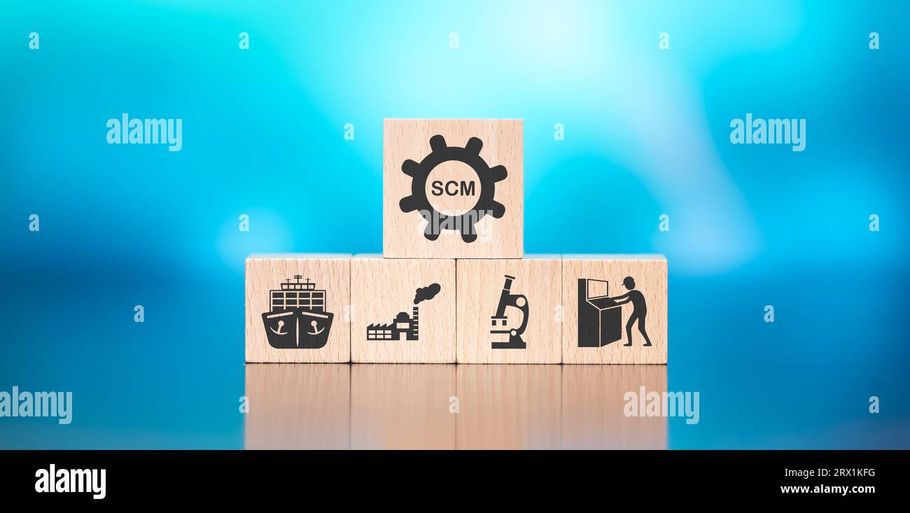 Wooden blocks with symbol of scm concept on blue background Stock Photo ...
