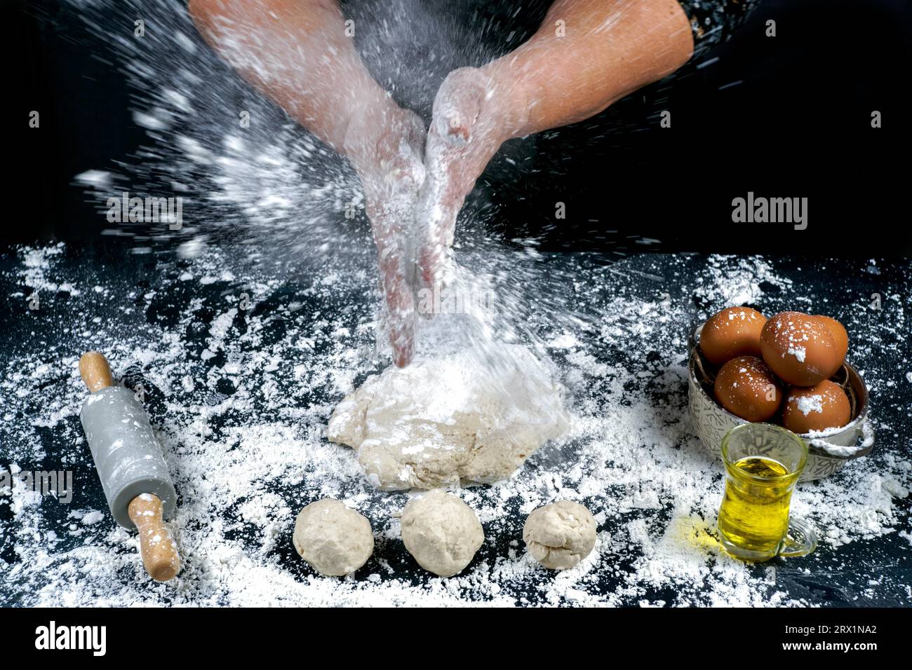 Woman sprinkling wheat flour, splash effect with a dough of flour to ...