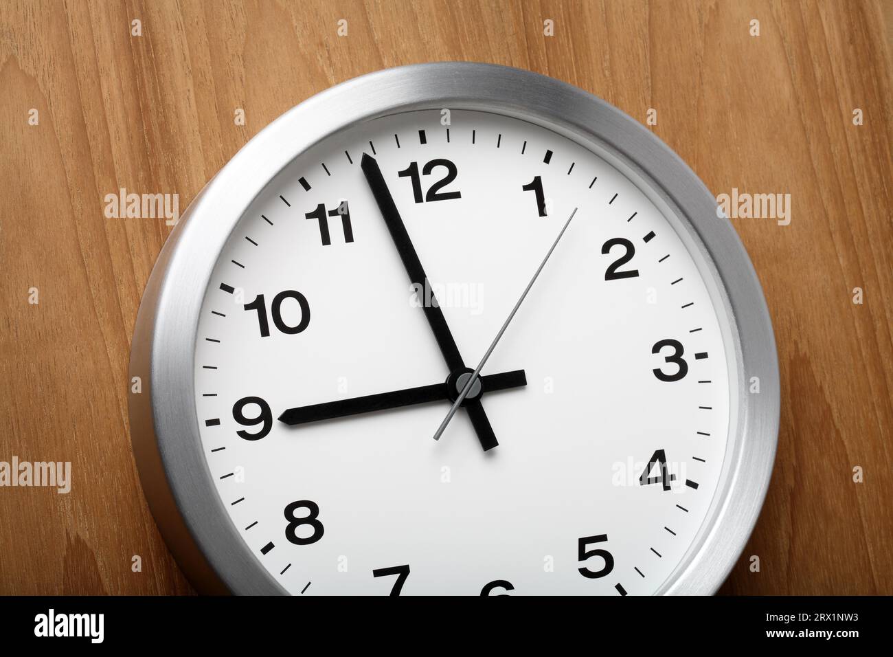 The aluminum wall clock is almost nine Stock Photo - Alamy