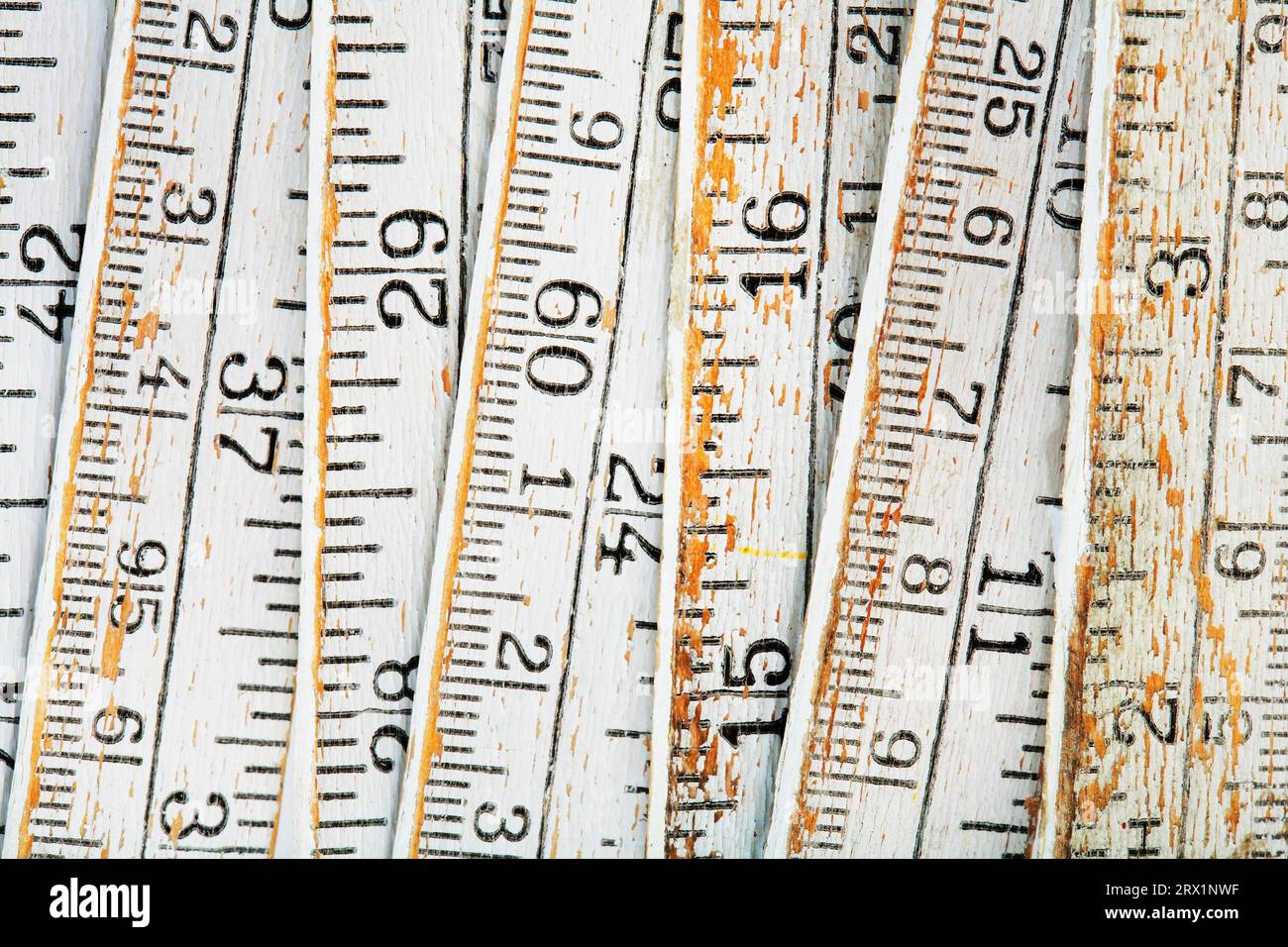 Old and worn white folding carpenters ruler in closeup Stock Photo - Alamy