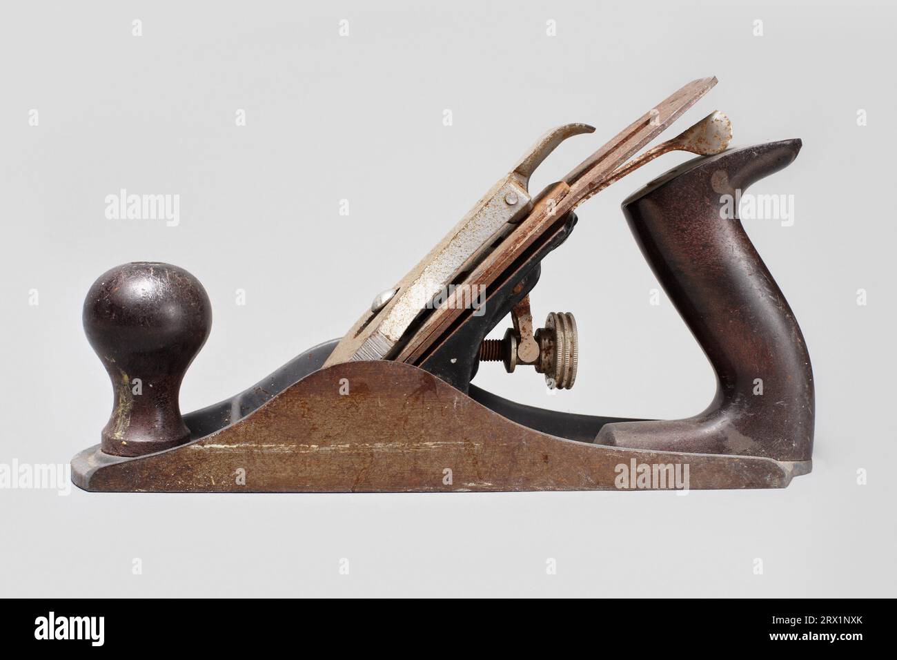 Old hand plane tool on gray background Stock Photo - Alamy