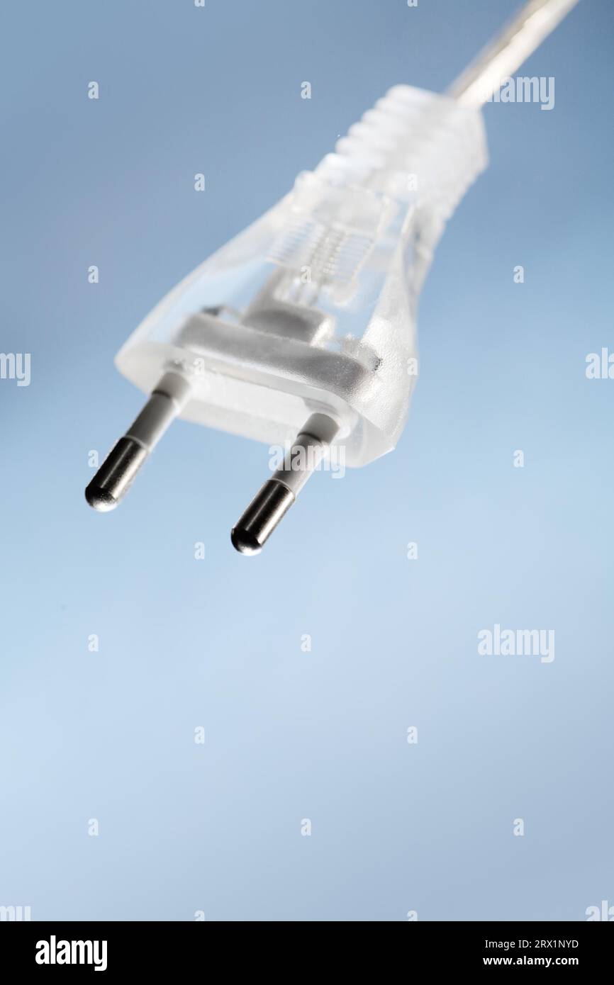 Translucent european power plug over a blue background Stock Photo - Alamy