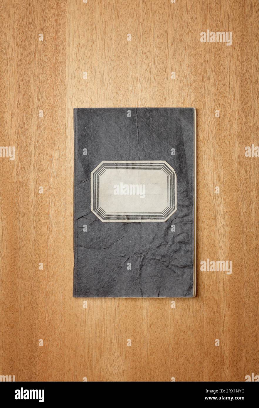 Old worn and wrinkled black notebook on wood Stock Photo - Alamy