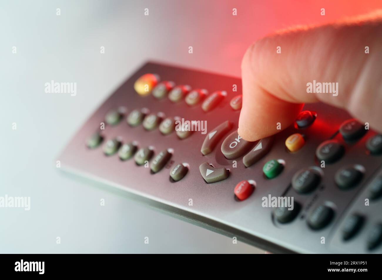 Digital television remote control in red light Stock Photo - Alamy
