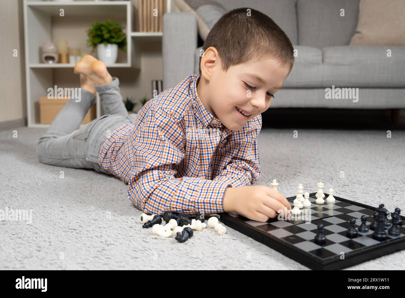 Little boy playing chess. Board games for children Stock Photo - Alamy