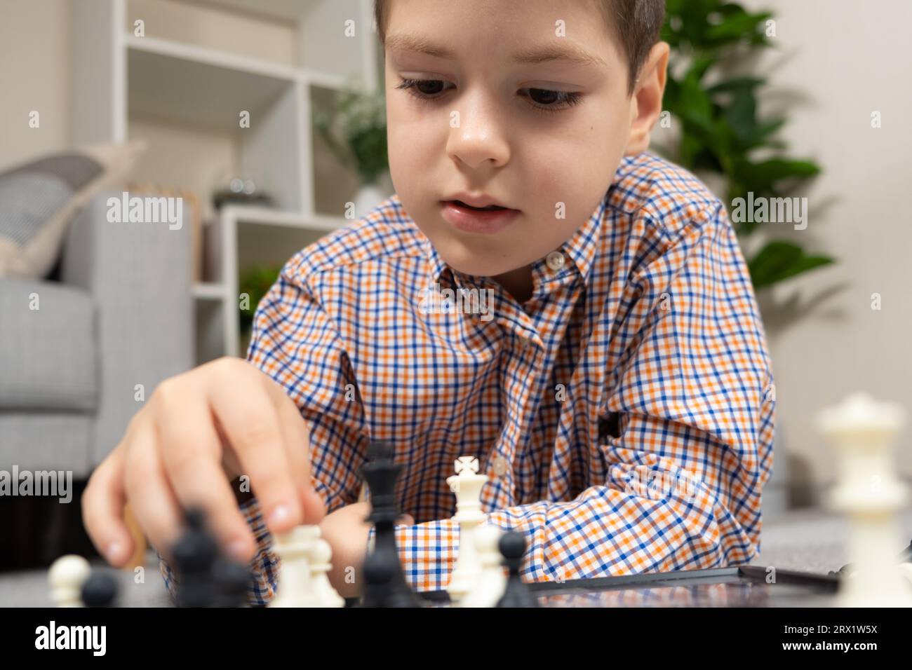 Little boy playing chess. Board games for children Stock Photo - Alamy