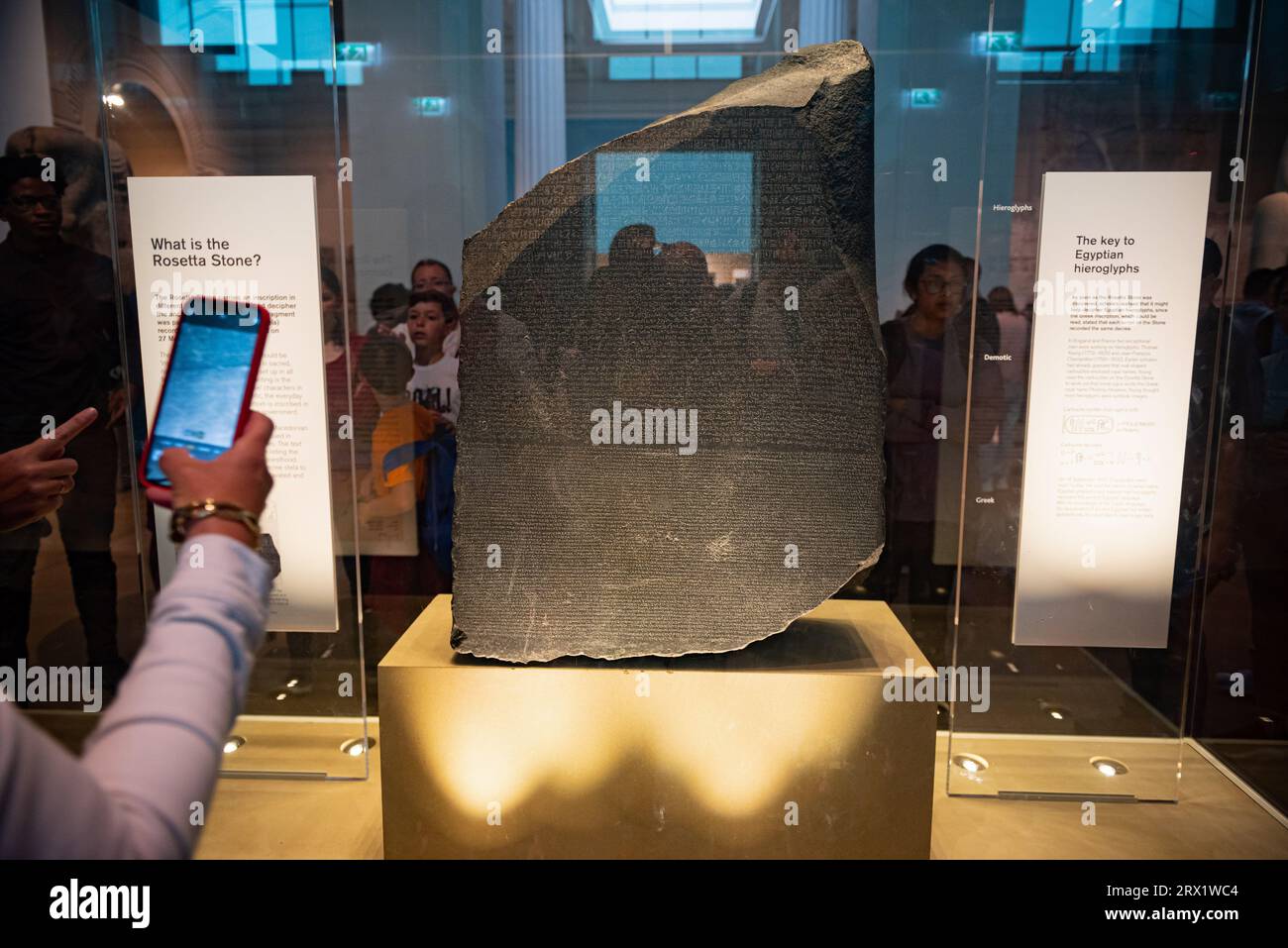 A tourist takes a photo of the Rosetta Stone on display in the British ...