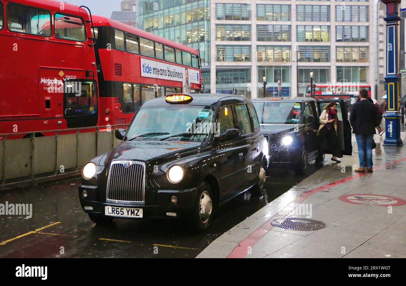 Taxis pulling up at the taxi rank outside Victoria Station during a ...