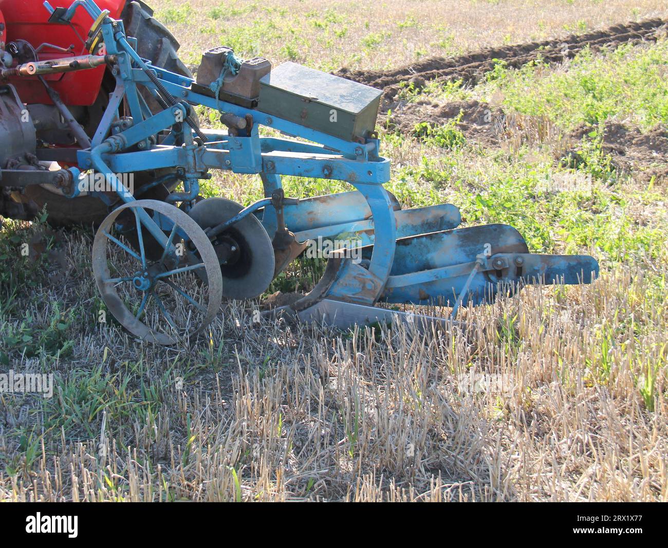 An Old Classic Farming Plough on a Vintage Tractor Stock Photo - Alamy