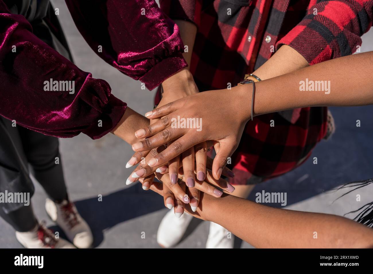 Top view of women joining hands together. Team and support concept ...