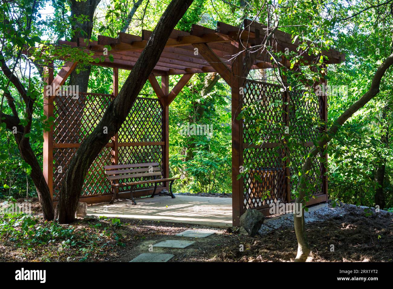 Wooden structure resting place with bench in Botanic Garden, Sopron ...