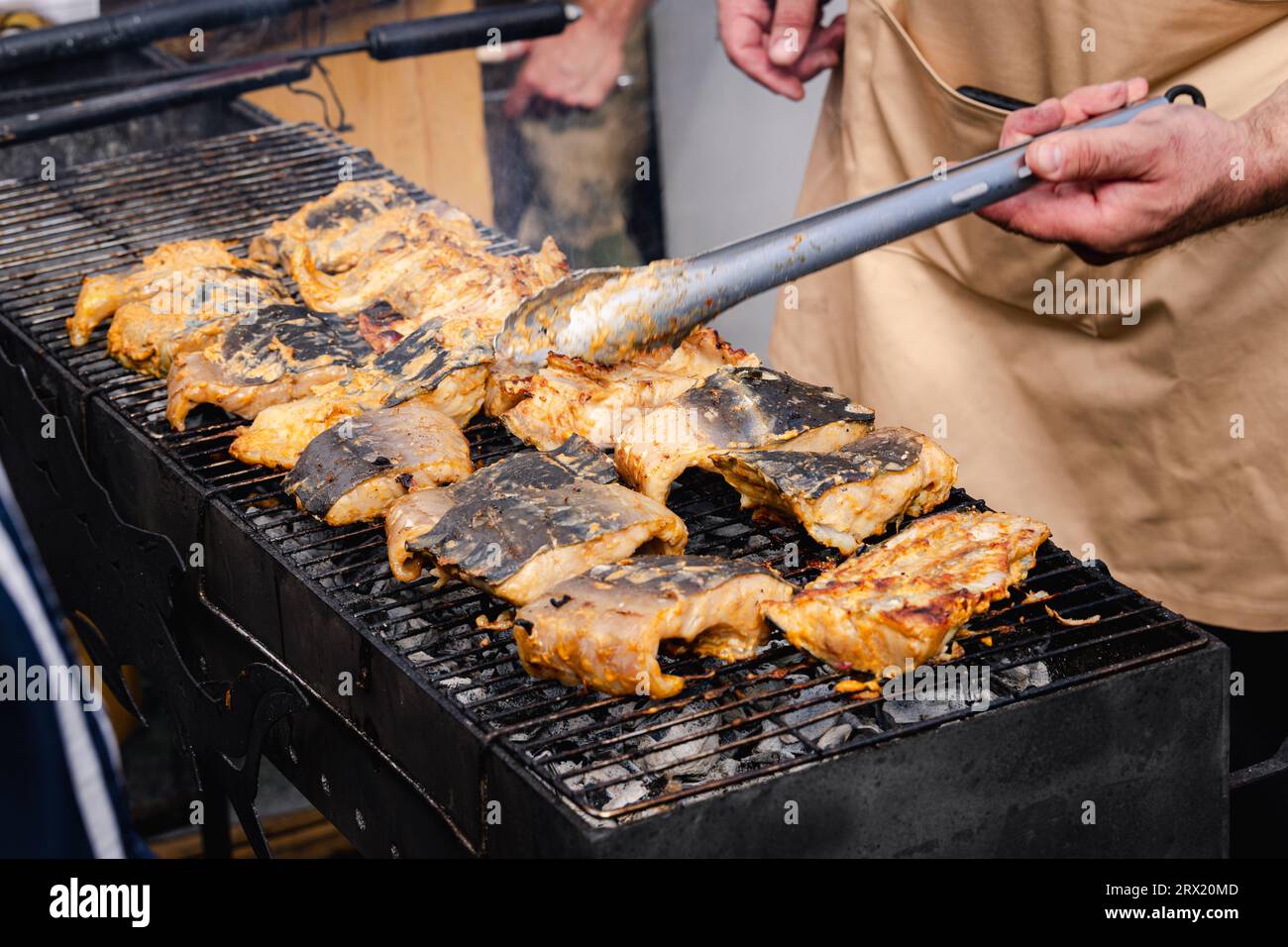 Cooking BBQ Fish. hands turn pieces of fish on the grill. Grilled ...