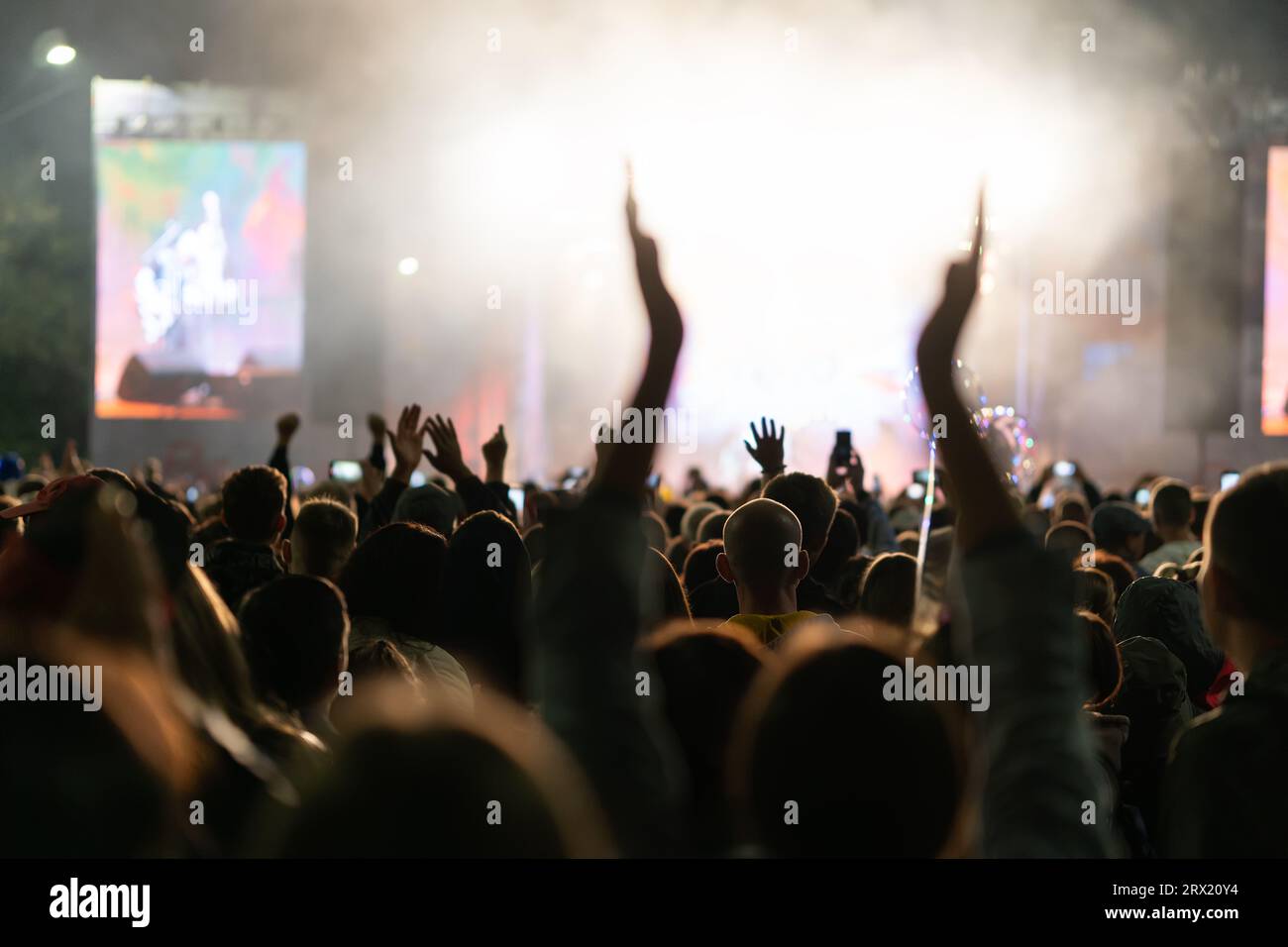 Rock Band Performing at a Concert in a NightClub. Front Row Crowd is ...