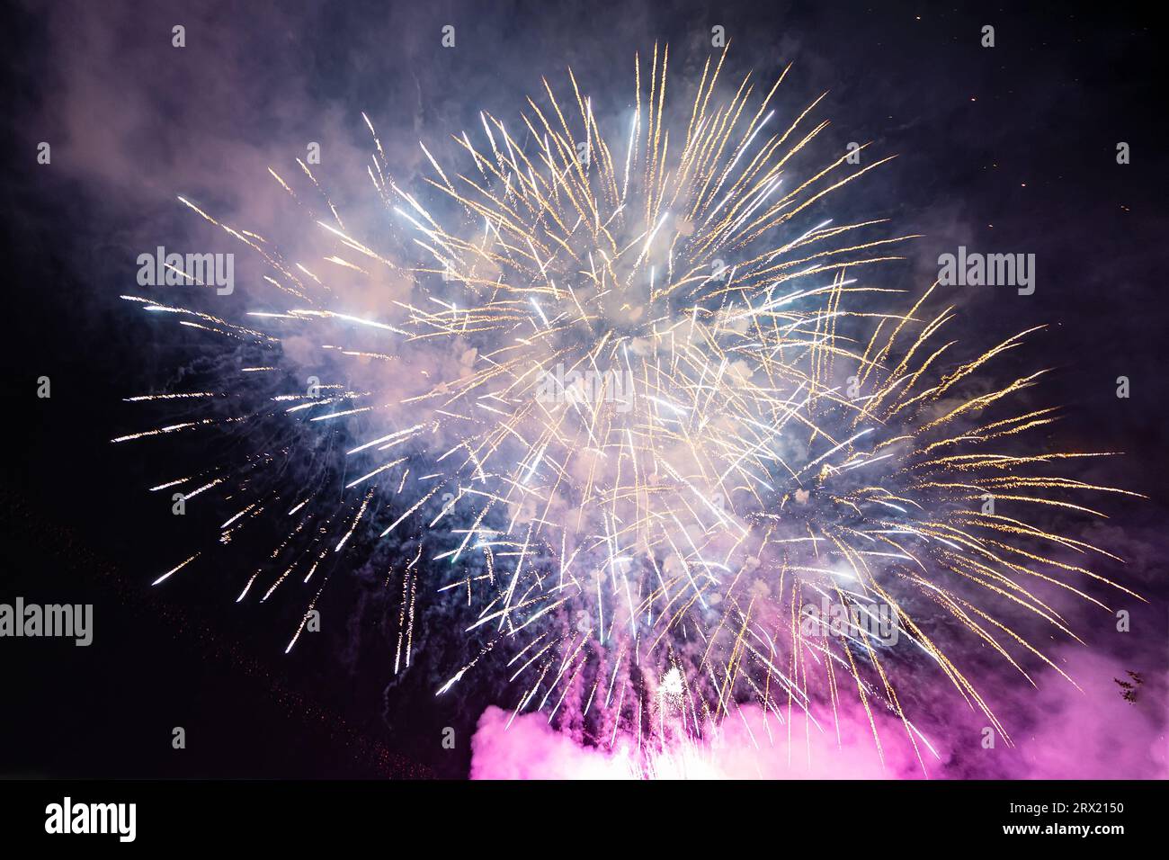Beautiful red and blue fireworks display lights up the sky during night ...