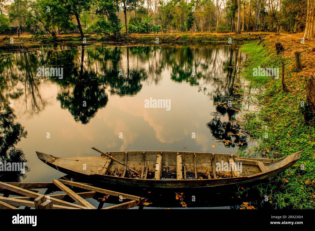 Reflection in moat & old row boat, Prasat Krahom (Red Temple), Prasat ...