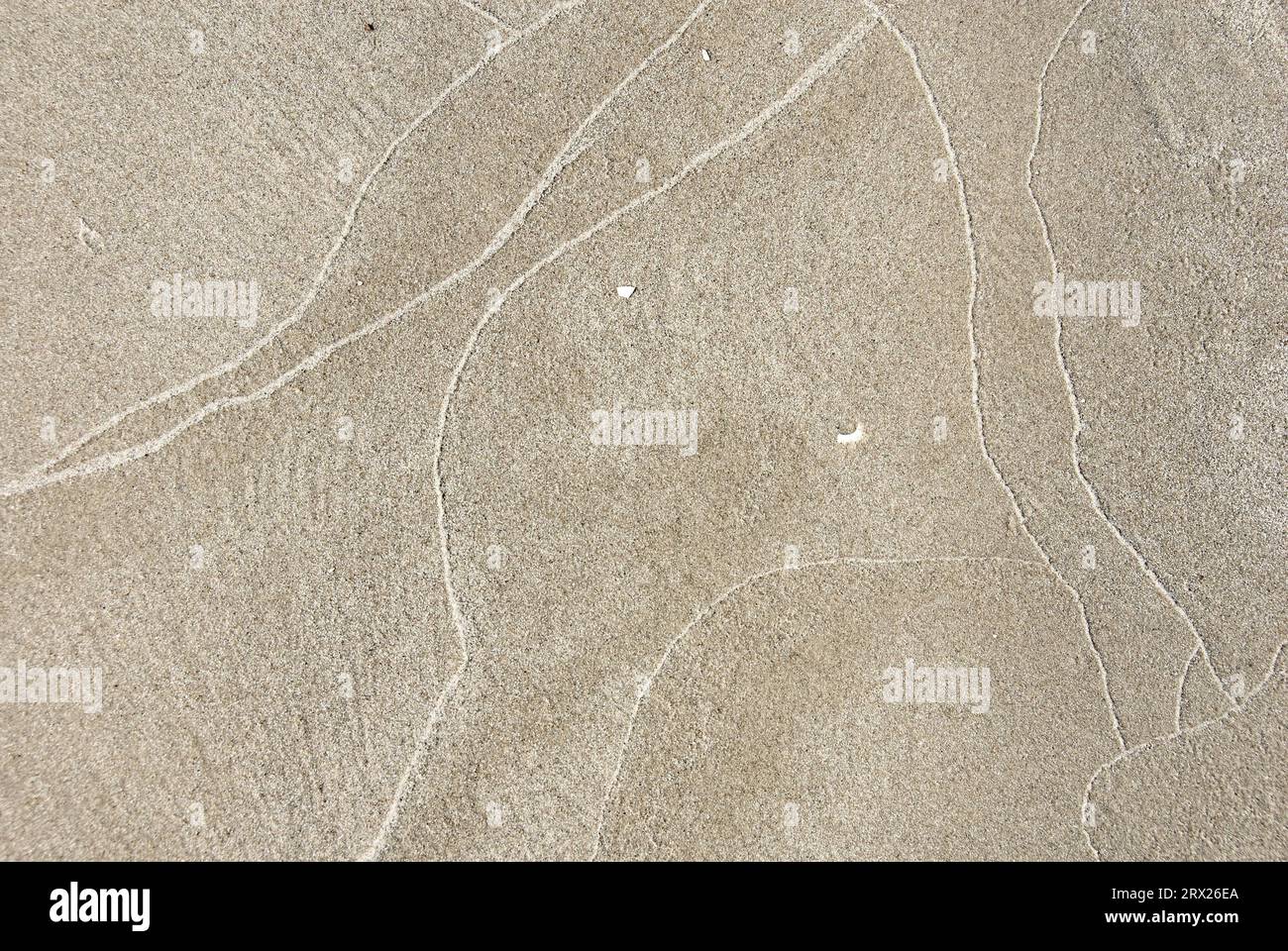 Sand at shoreline with structures Stock Photo - Alamy