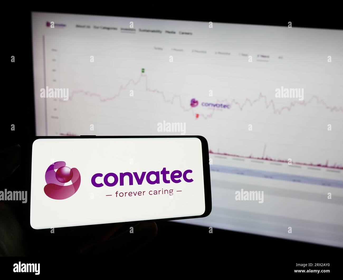 Person holding mobile phone with logo of British medical company Convatec Group plc on screen in ...
