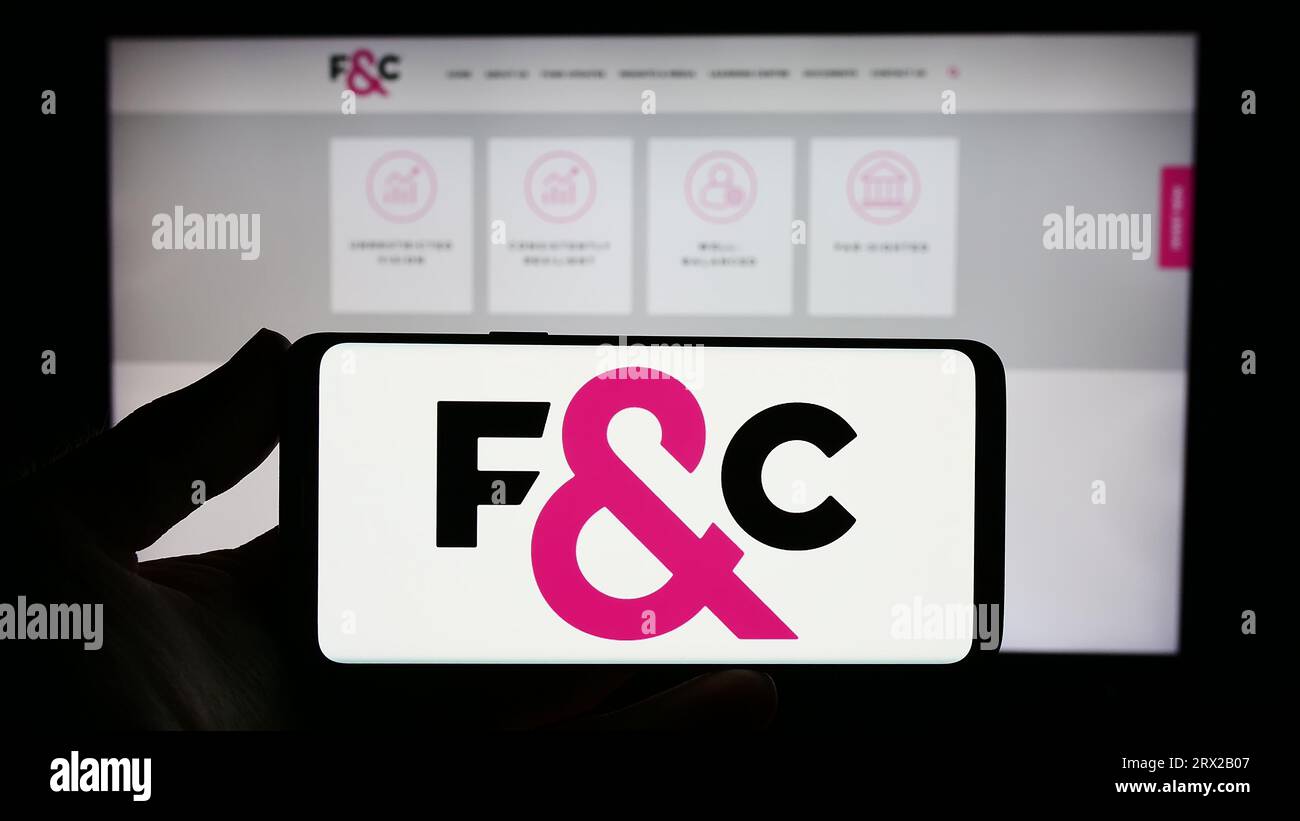 Person holding smartphone with logo of company Foreign Colonial ...