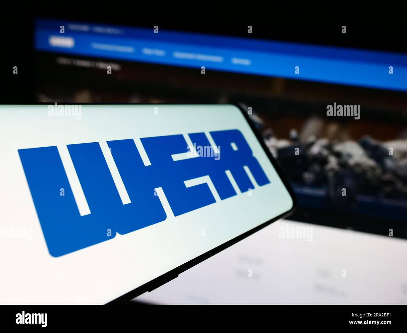 Smartphone with logo of British company The Weir Group plc on screen in ...