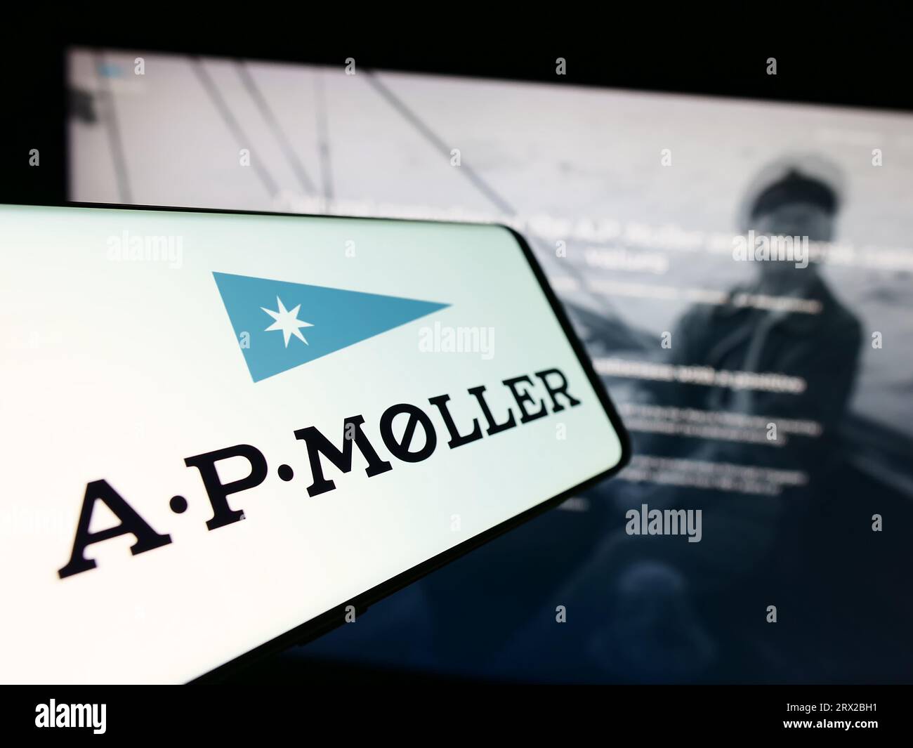 Mobile phone with logo of Danish company A.P. Moller Holding AS (APMH ...