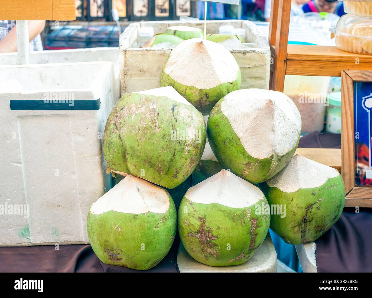 Fresh green coconuts on counter selling on street market Stock Photo ...
