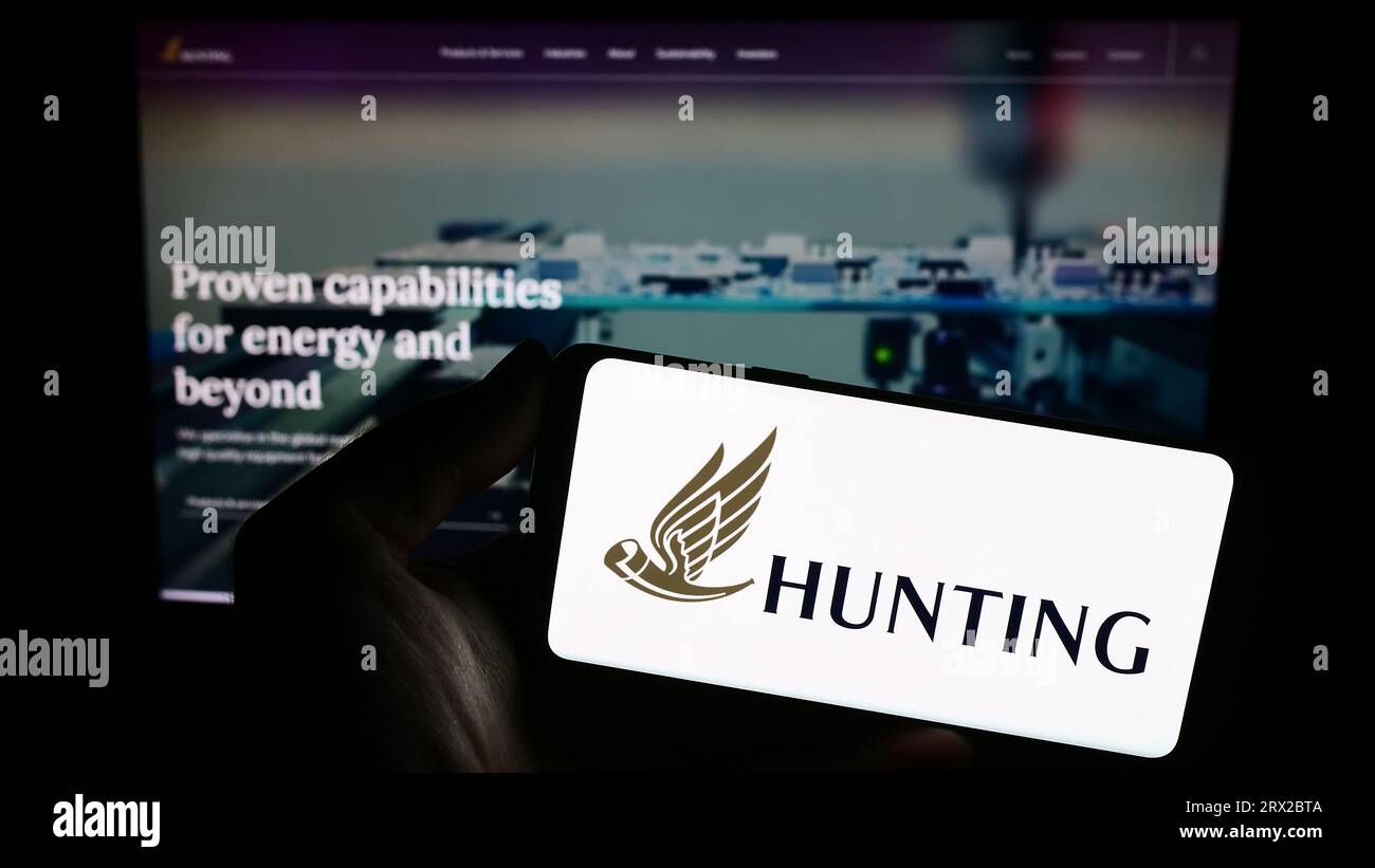 Person holding smartphone with logo of British energy technology ...