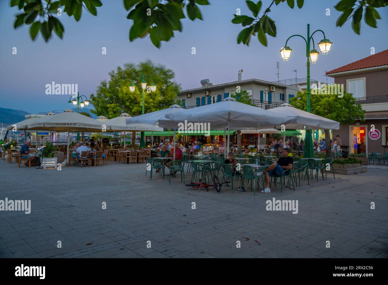 View of cafe and bar in PlateA a Central Square at dusk, Lixouri ...