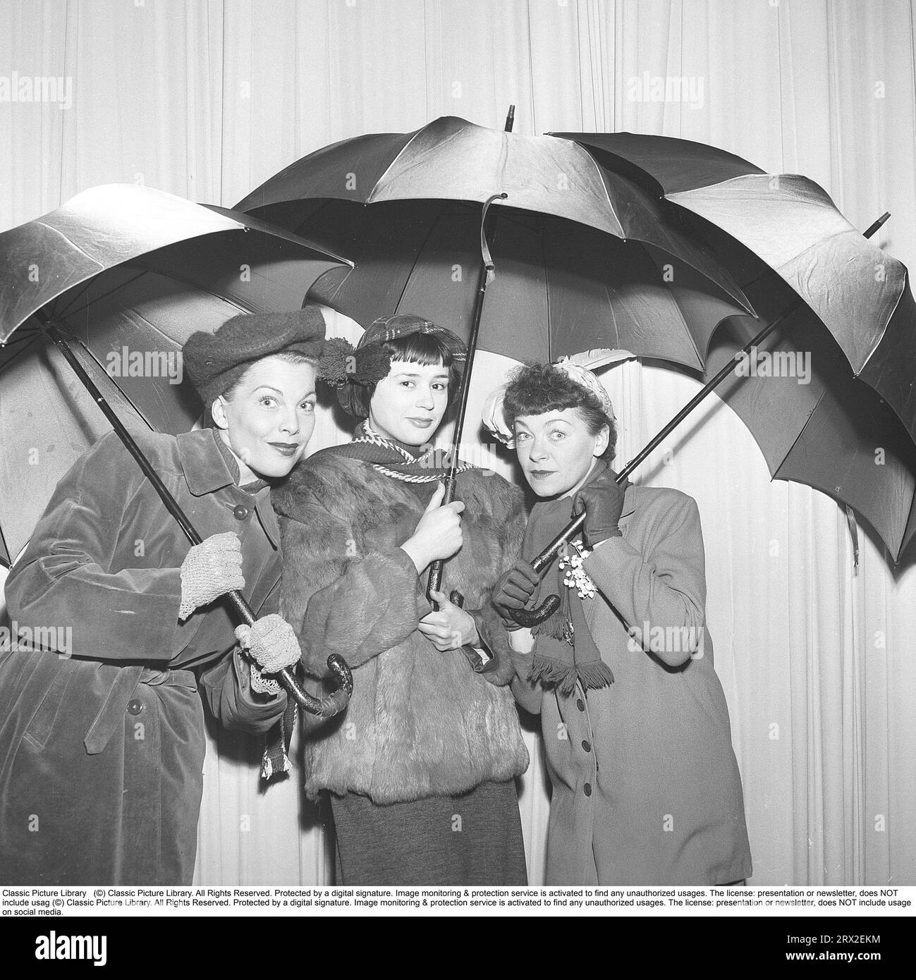 Three women under umbrellas in the 1950s. The actor Harriet Andersson ...