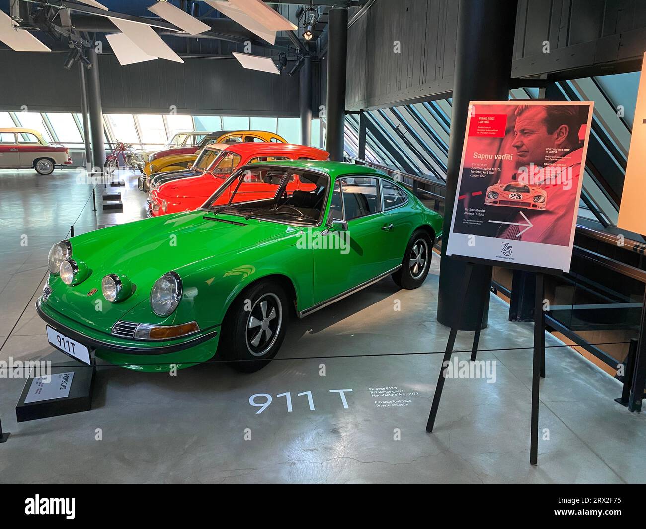 Riga, Latvia. 21st Sep, 2023. A Porsche model stands next to a poster ...