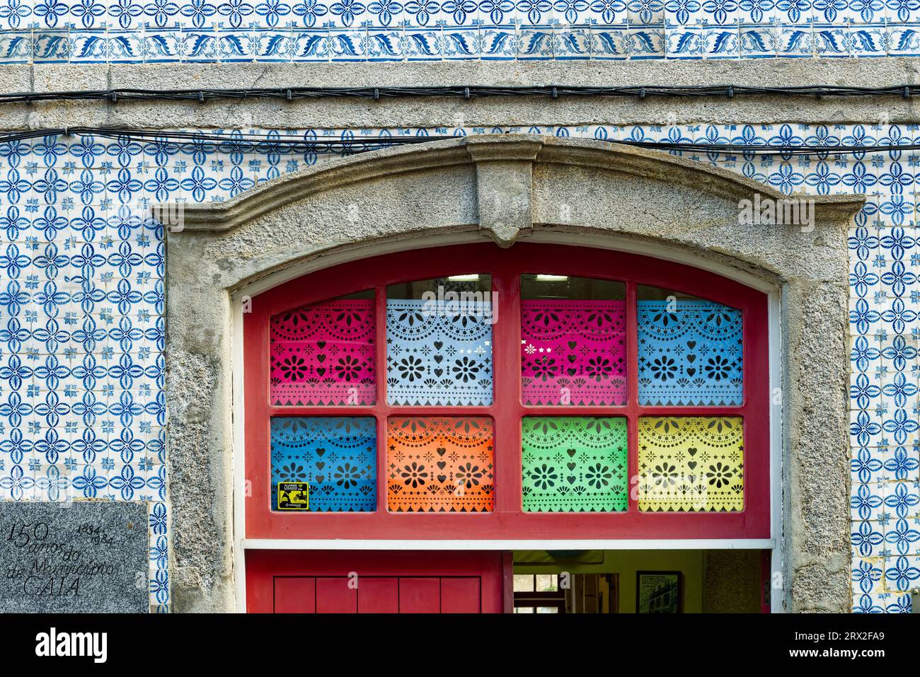 Door arch surrounded by Portuguese Azulejos tiles and windows with lace ...