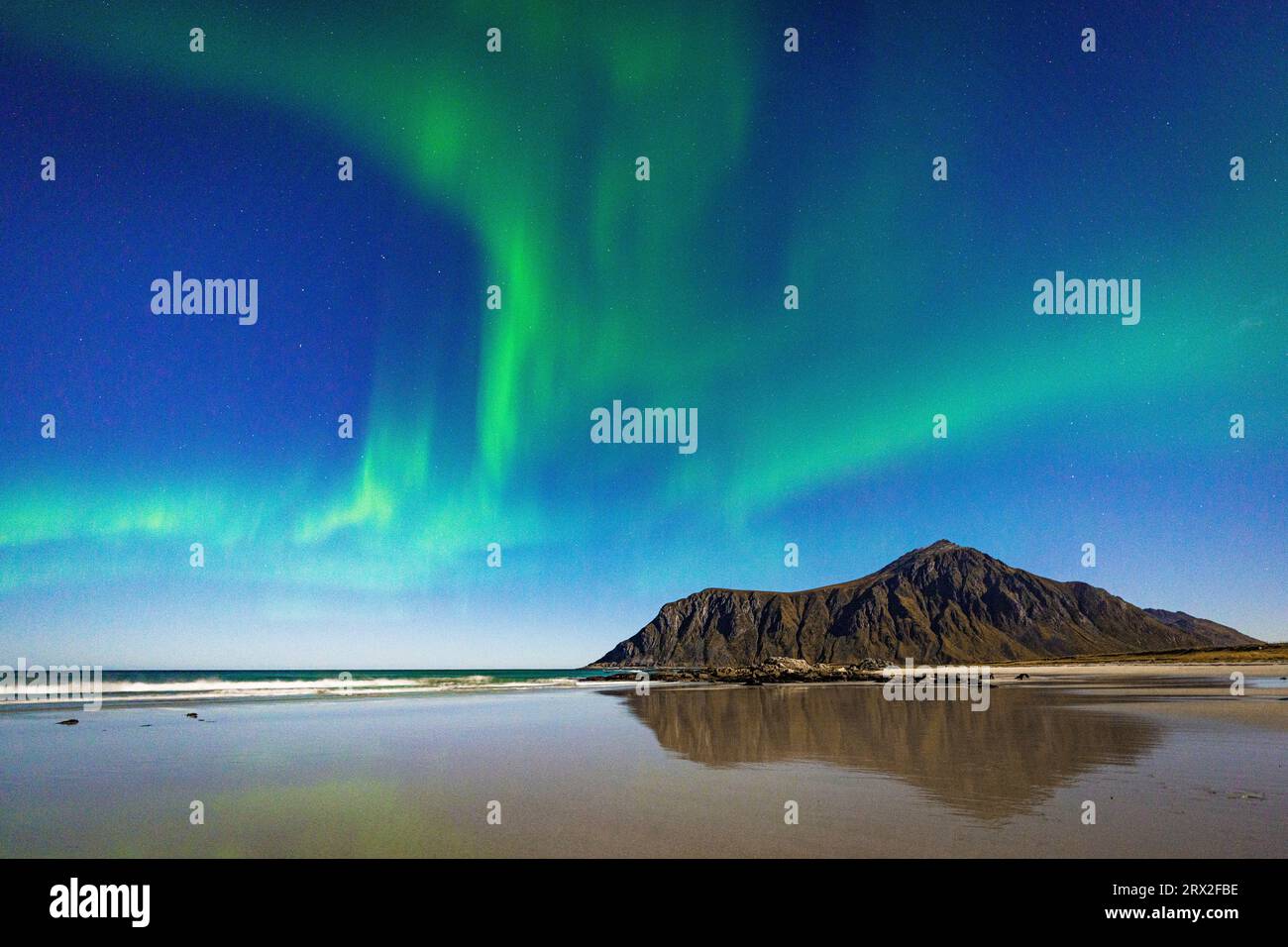 Aurora Borealis (Northern Lights) over mountains reflected on ...