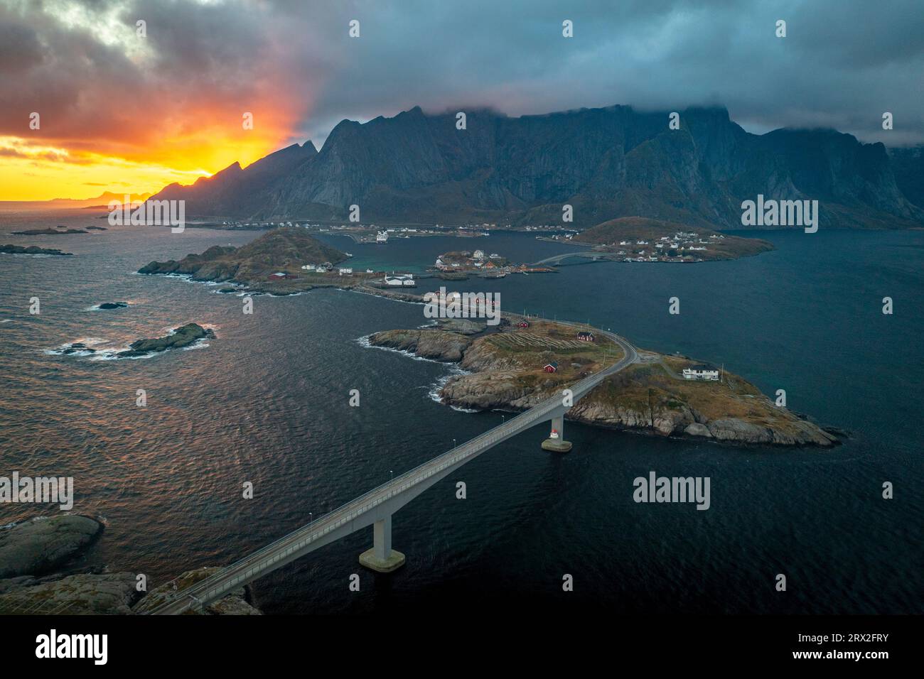 Aerial view of a bridge crossing the fjord under a dramatic sky at ...