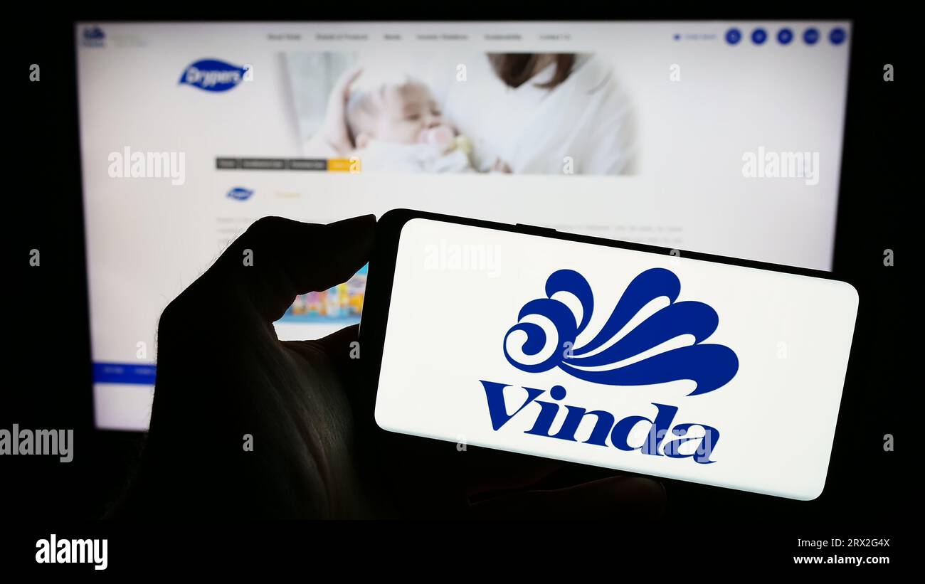 Person holding cellphone with logo of company Vinda International ...