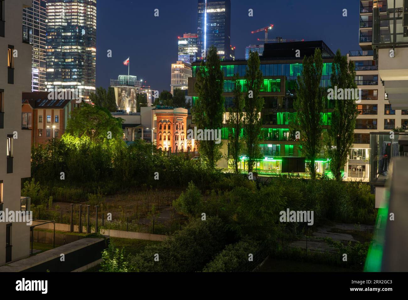 Night city lights. View of the Warsaw Uprising Museum. New houses glow ...