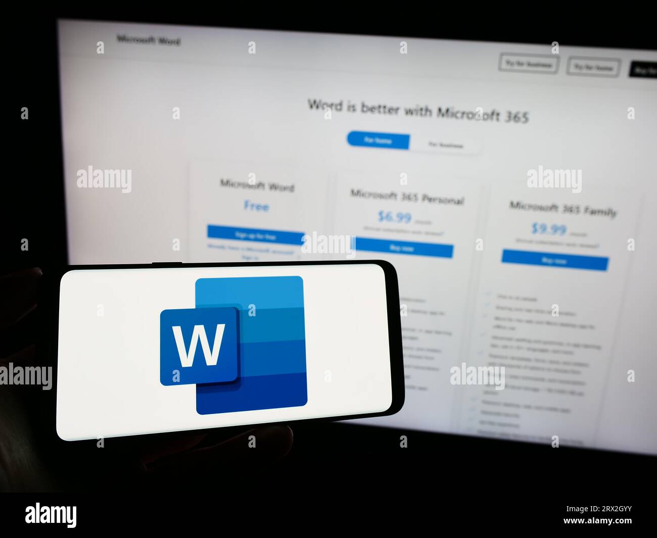 Person holding mobile phone with logo of word processing software ...